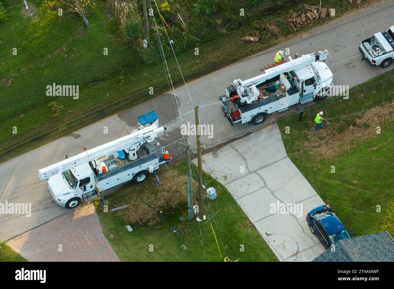 Aerial view of electrician workers repairing damaged power lines after ...