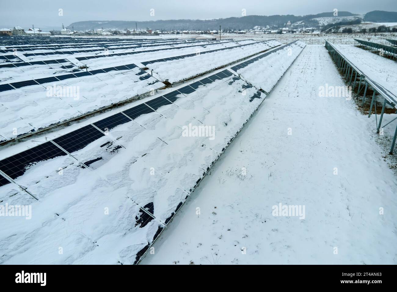 Aerial view of snow melting from covered solar photovoltaic panels at ...