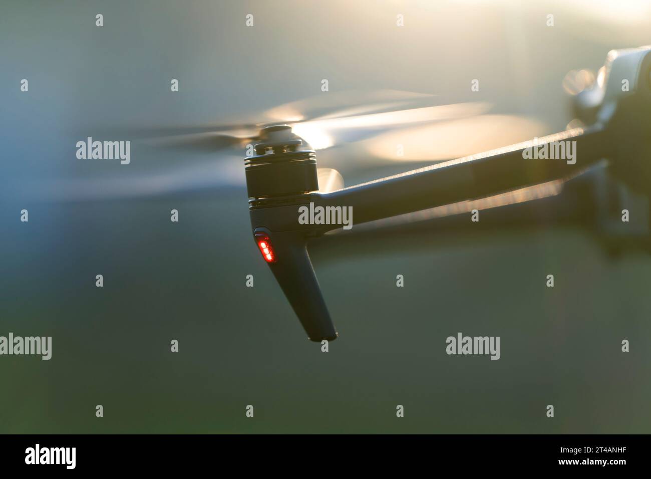 Drone aircraft with blurred fast rotating propellers and video camera ...