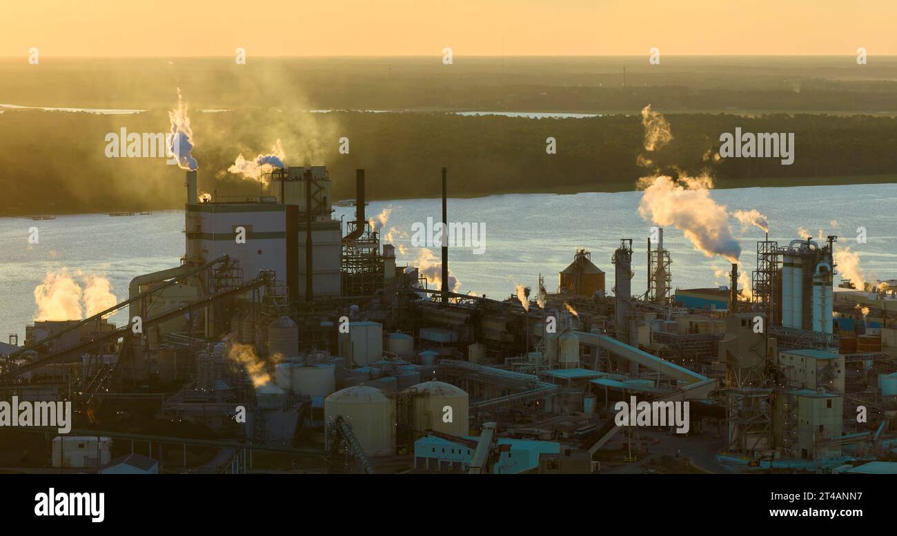 Huge factory with high chimneys polluting atmosphere with carbon ...