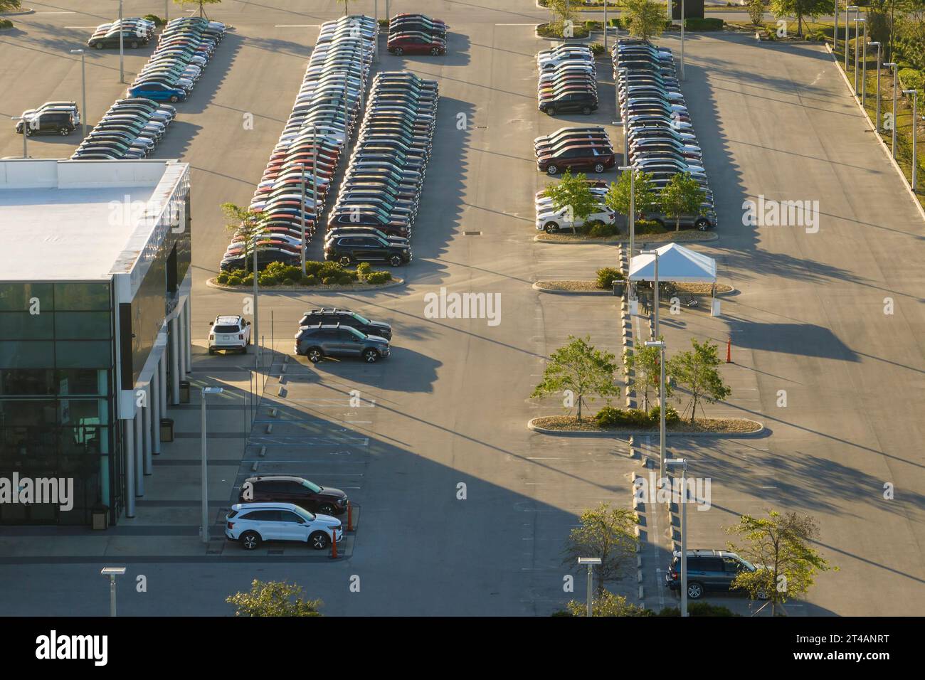 Large parking lot of local dealer with many brand new cars parked for ...