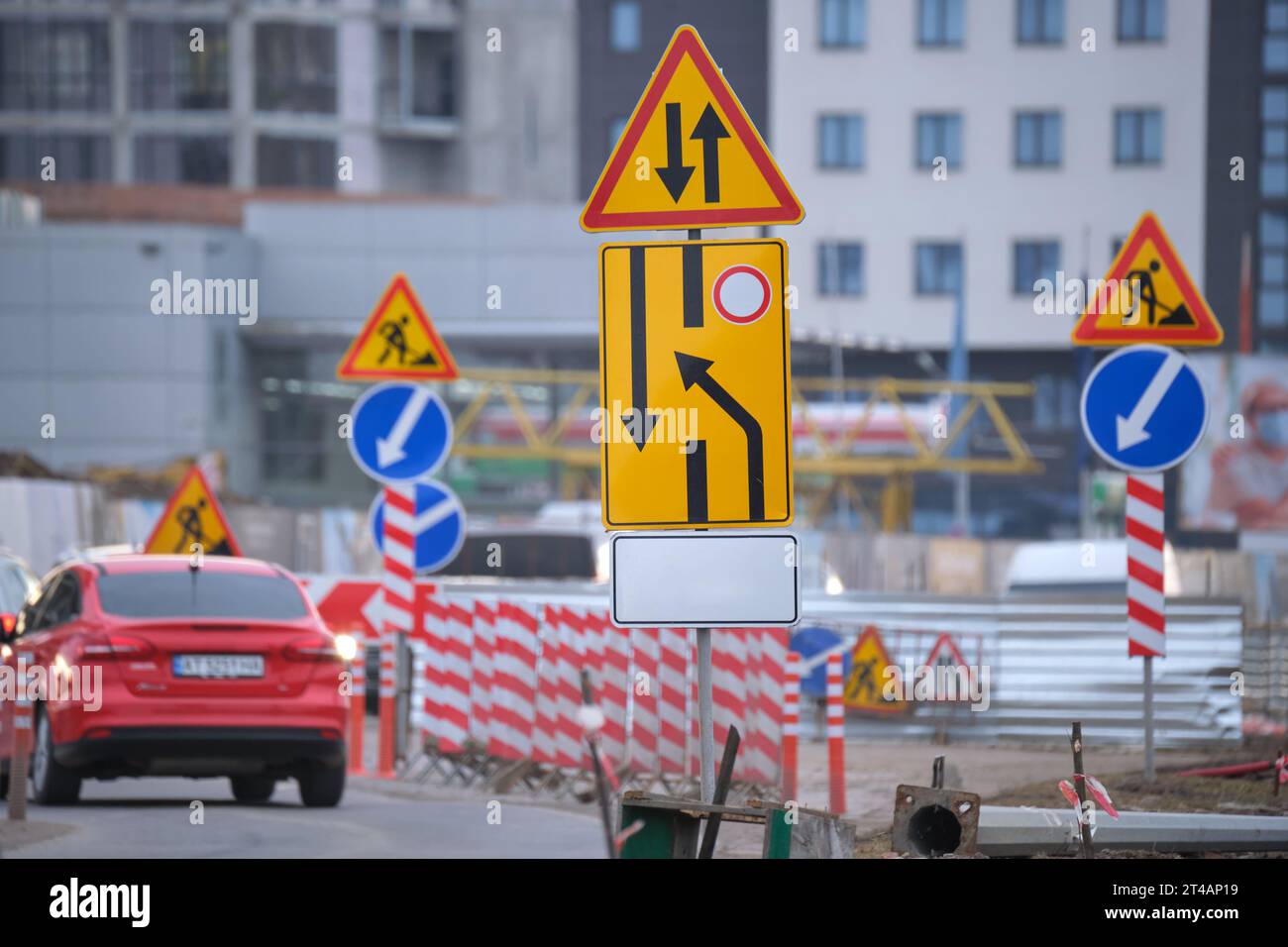 Roadworks warning traffic signs of construction work on city street and ...