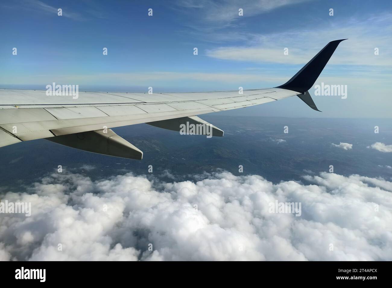 View through airplane window of commercial jet plane wing flying high ...