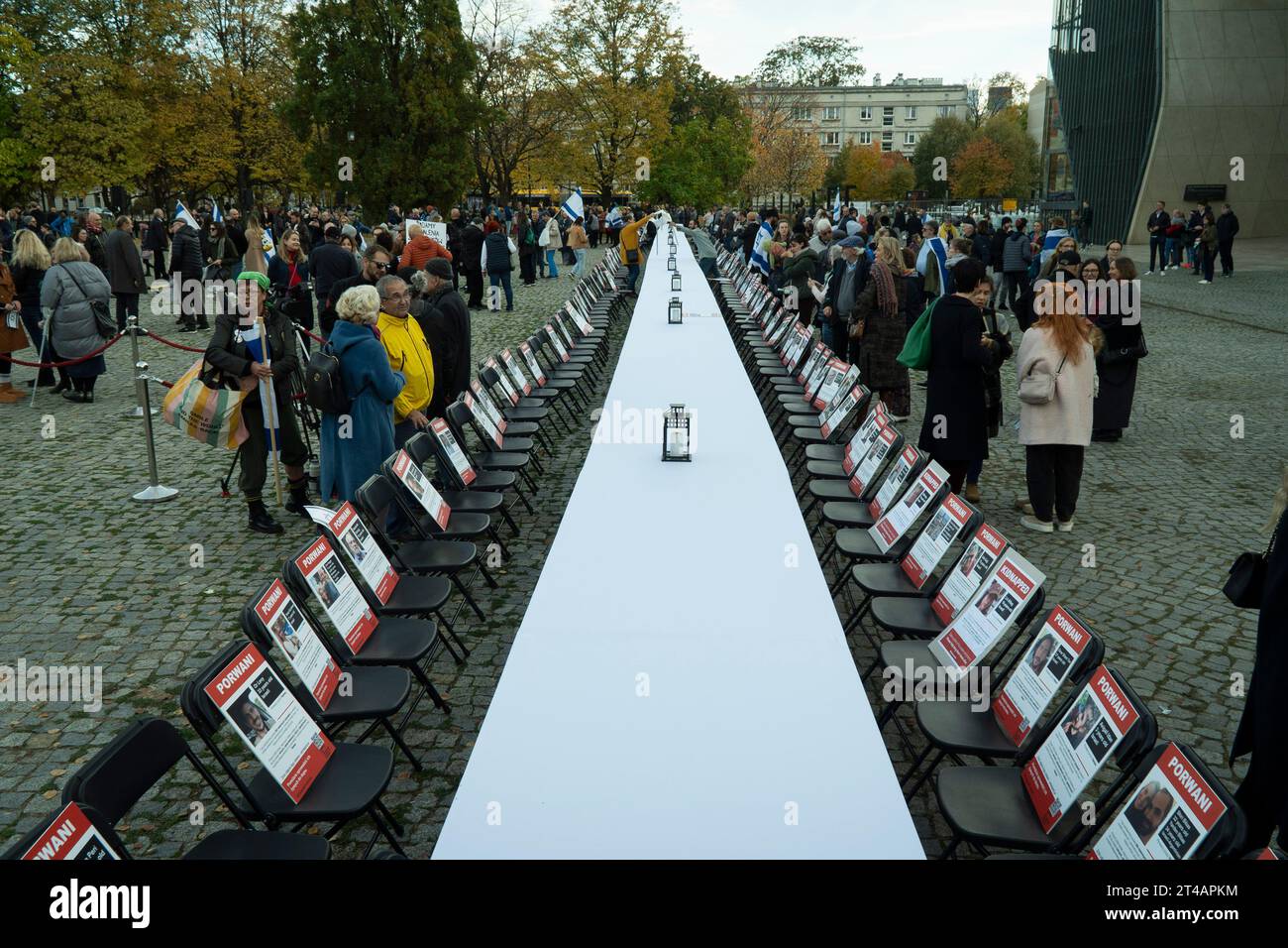 Signs with photos of victims are seen during a vigil in Warsaw, Poland ...
