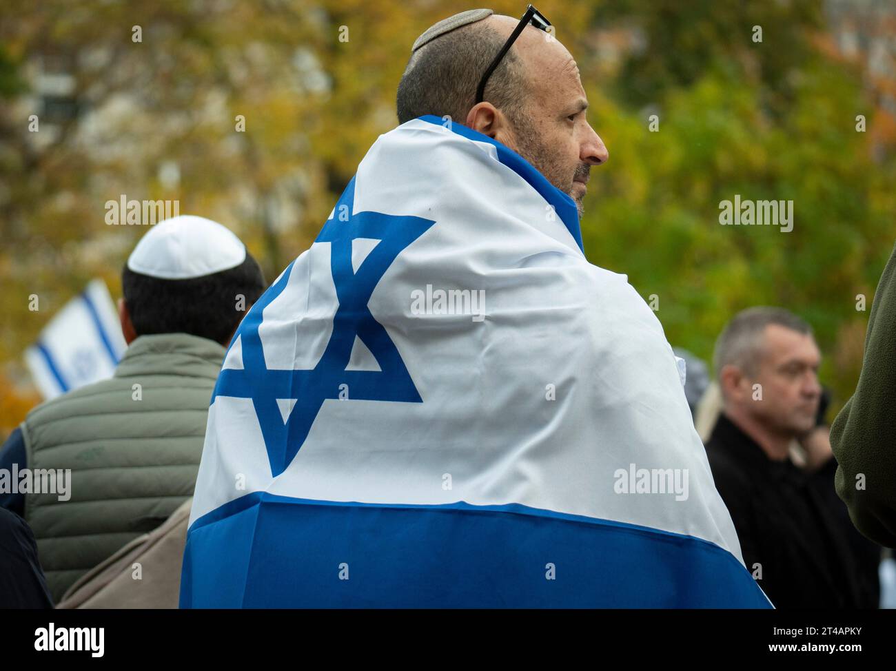 A man wearing an Israeli flag is seen during avigil in Warsaw, Poland ...