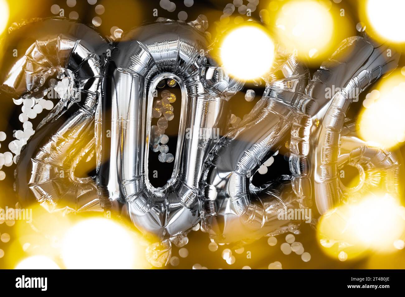 Holiday bokeh garland Happy new year 2026 metallic balloons with confetti on dark black ...