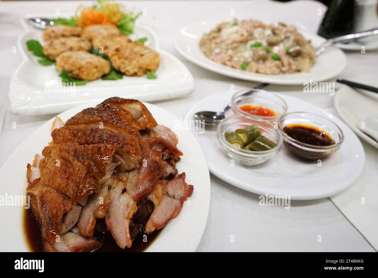 Assorted Chinese food- Stir fry pork noodle with black soy sauce served ...