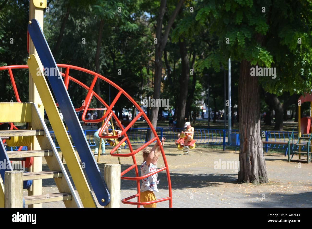Little children run around and play in the playground. Game center for ...