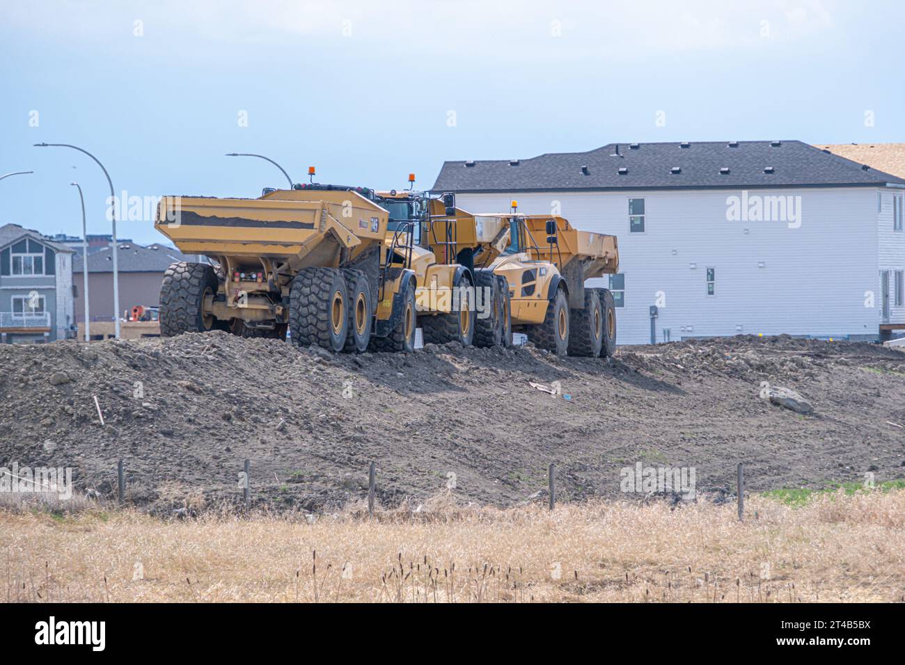 Earth movers on a new development construction site Stock Photo - Alamy