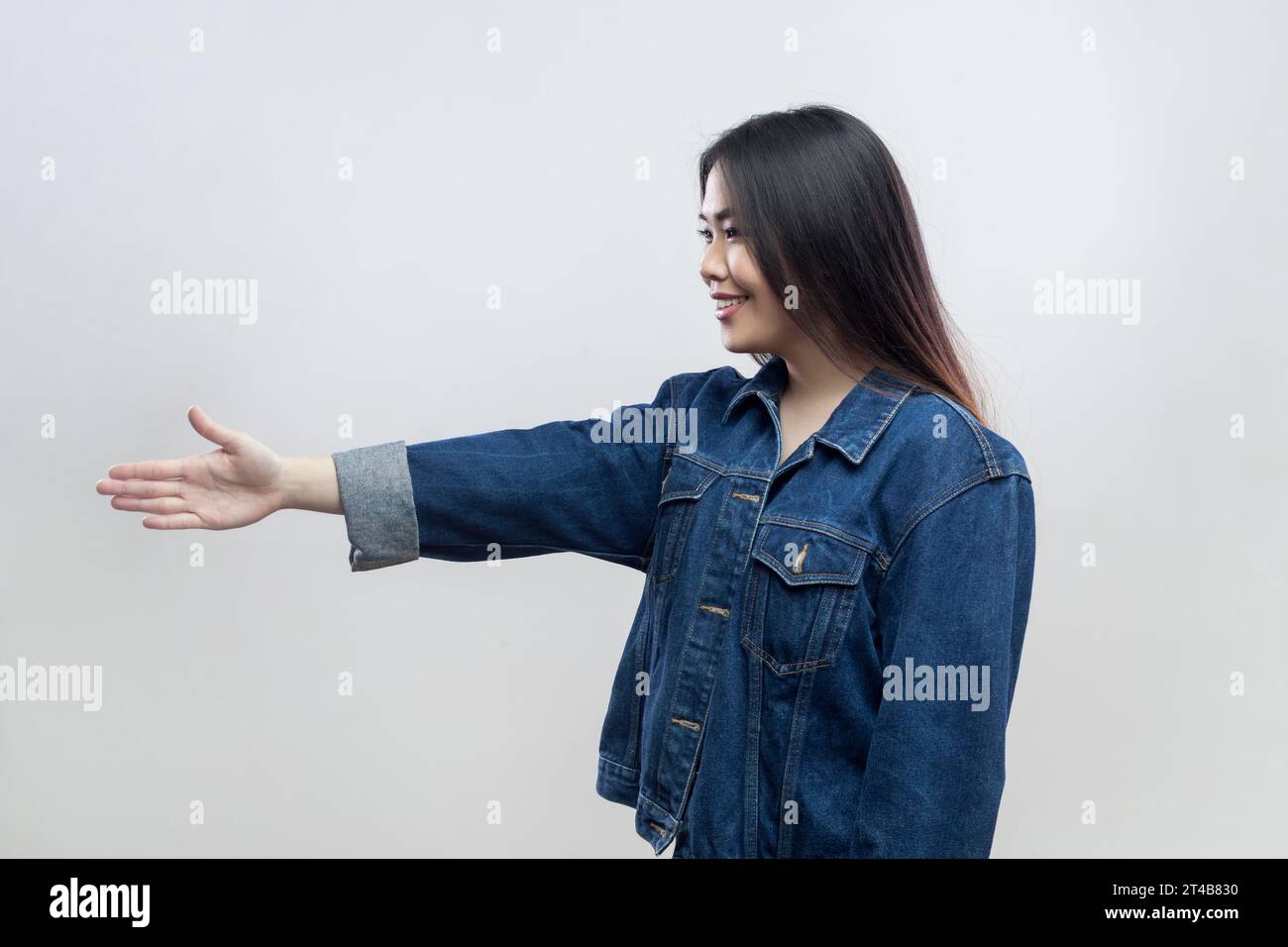 Hello, nice to meet you. Portrait of brunette woman in blue denim ...