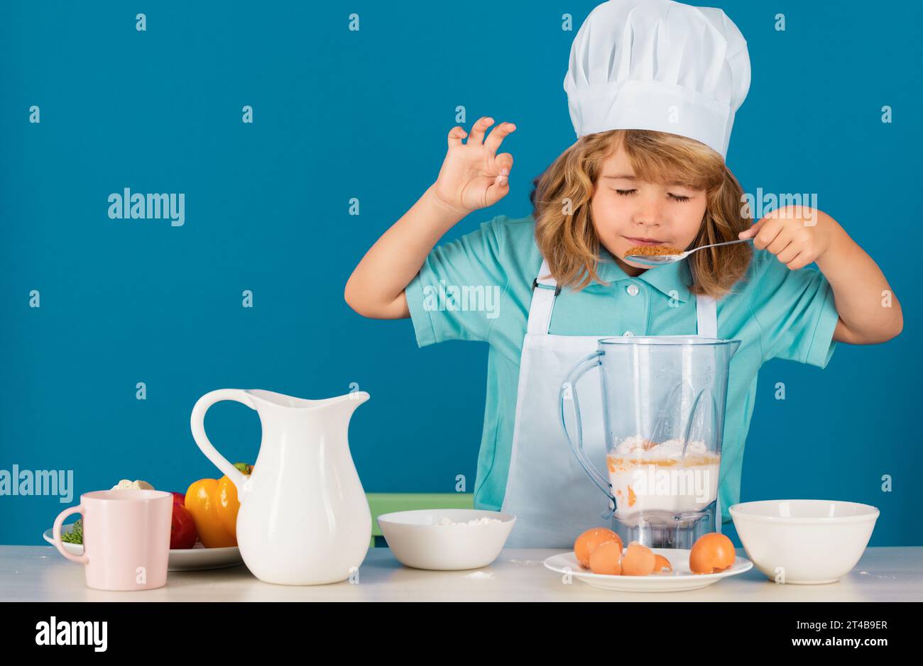 Cooking children. Chef kid boy making fresh vegetables for healthy eat ...