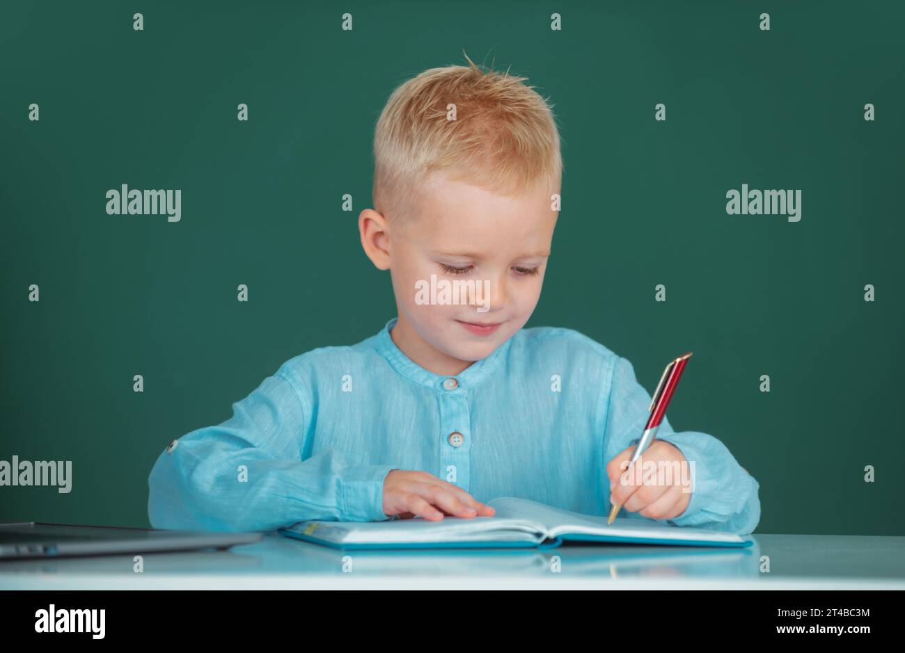 Pupil near chalkboard during lesson at primary school, close up ...