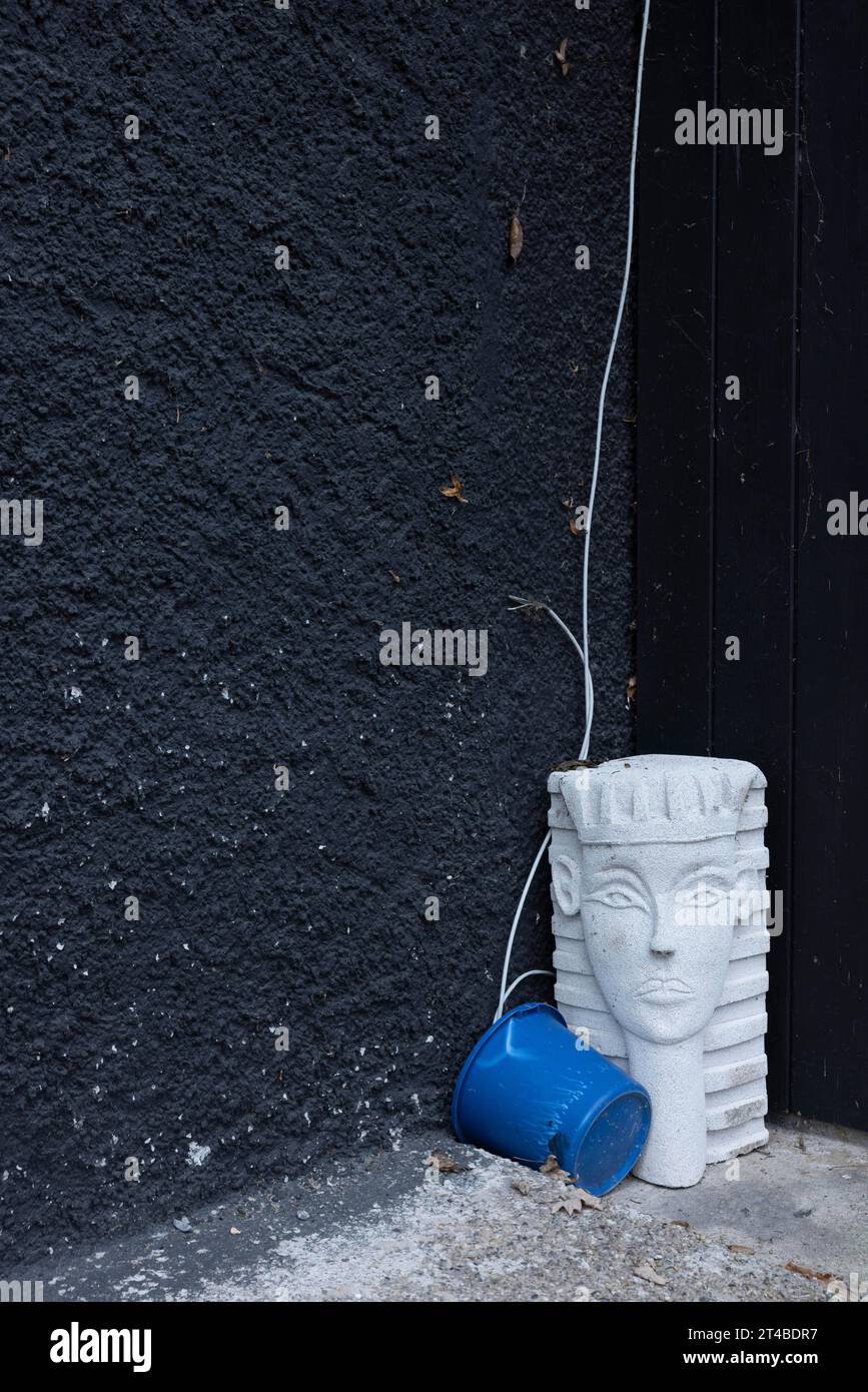 Bizarre still life with a sphinx from the hardware store and a blue ...