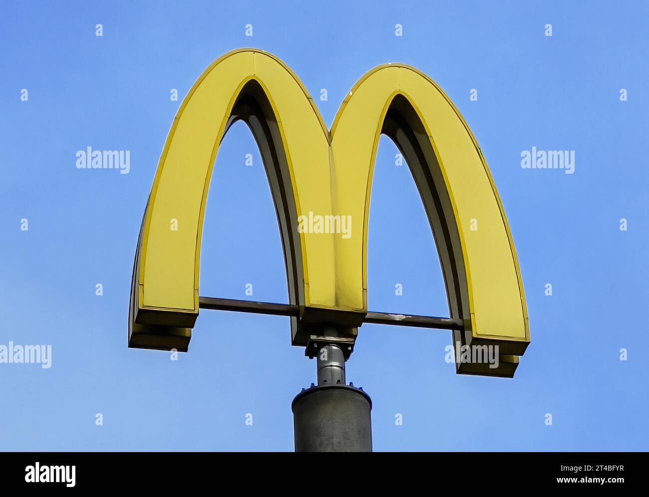 Giant pole-mounted logo yellow M of fast food restaurant McDonald's ...