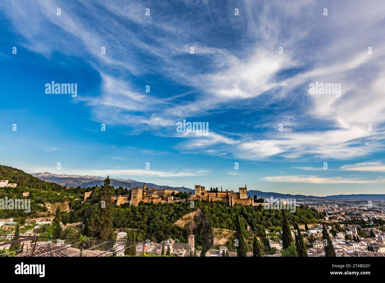 Alhambra as seen over the roofs of the buildings in Granada, Andalusia ...
