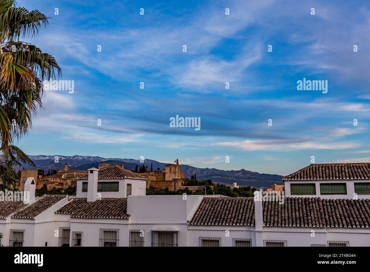 Alhambra as seen over the roofs of the buildings in Granada, Andalusia ...