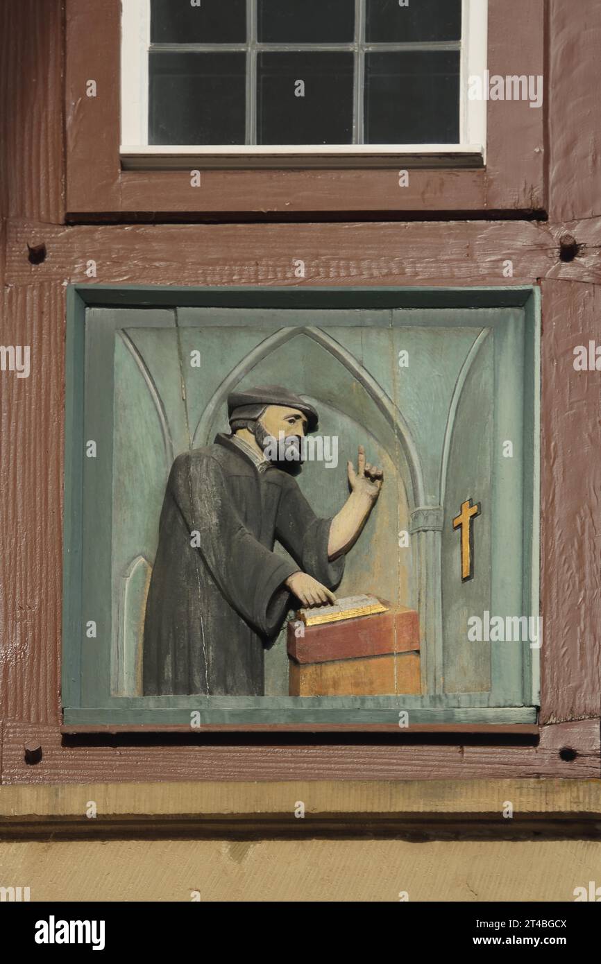 Relief with priest at lectern preaching from bible, talk, cross, speech ...