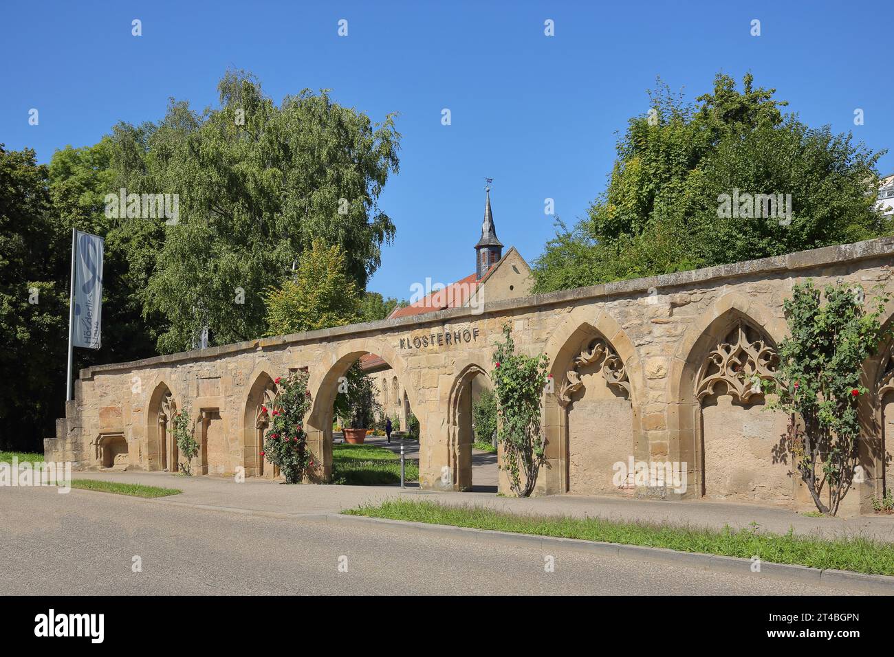 Historical stone wall with archways and monastery courtyard, church ...