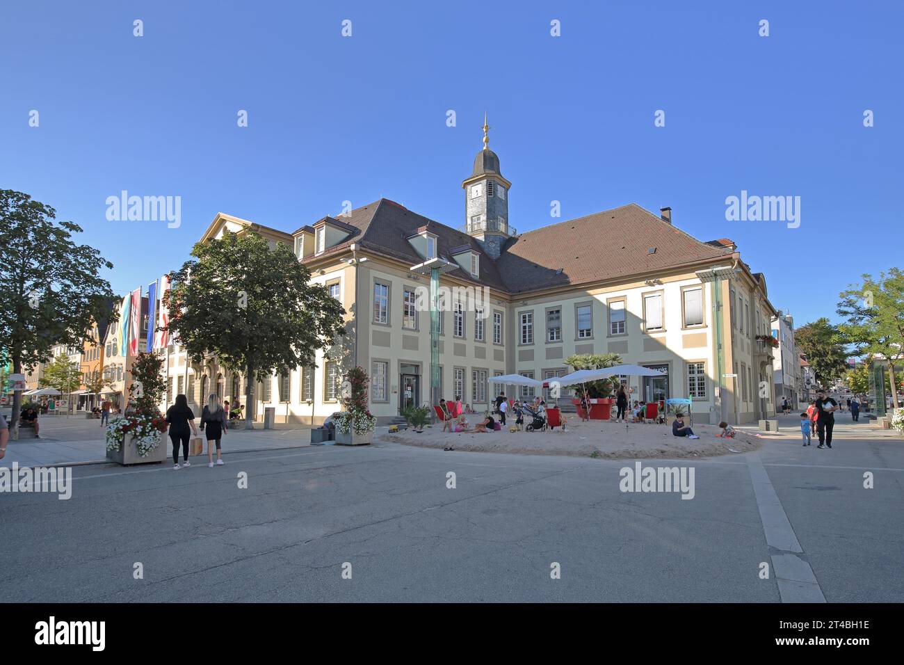 Sandy beach beach at the market place with pedestrians and town hall ...
