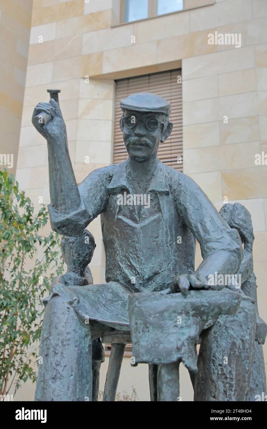 Sculpture with historical shoemaker, figure, bronze, sitting ...