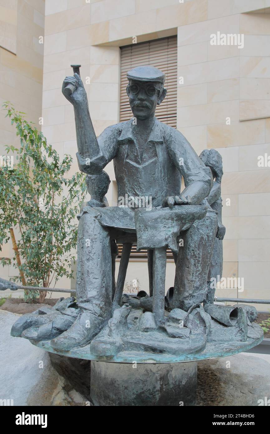 Sculpture with historical shoemaker, figure, bronze, sitting, craftsman ...