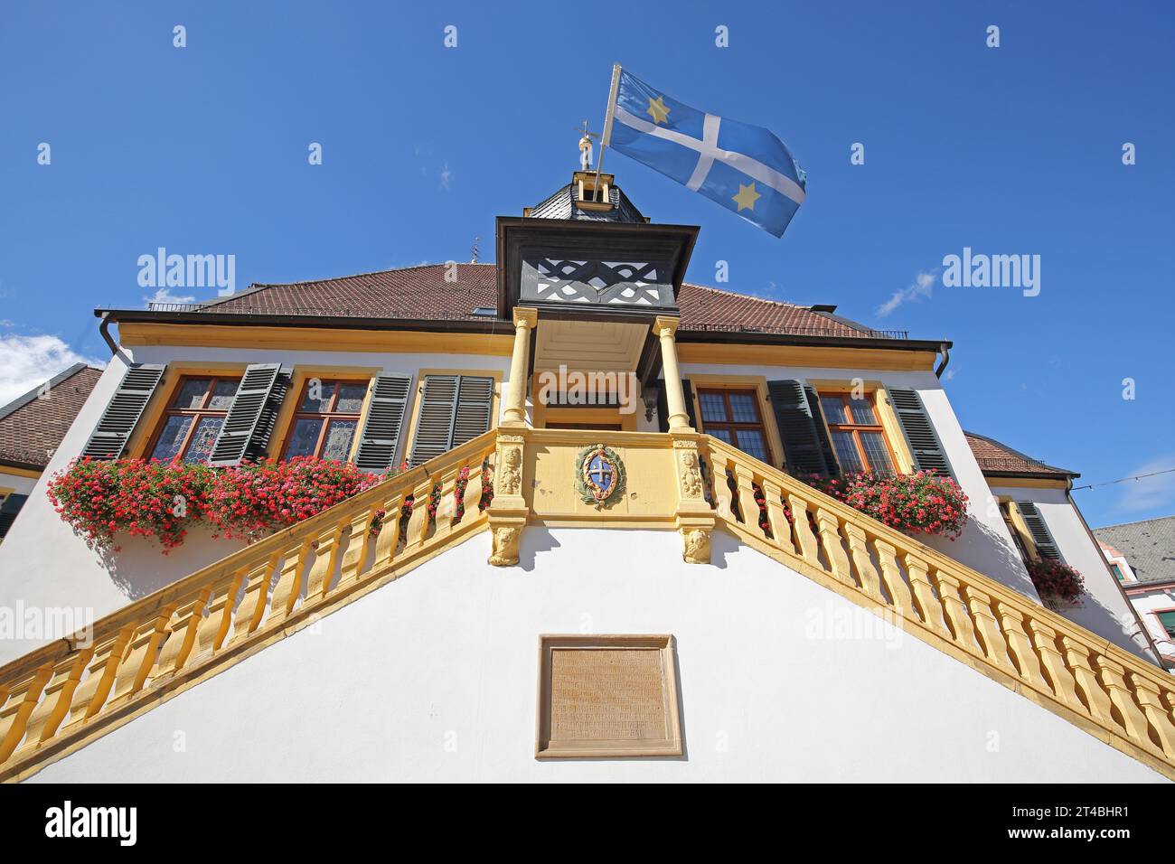 Historic town hall built 1532 with town flag, view upwards, landmark ...
