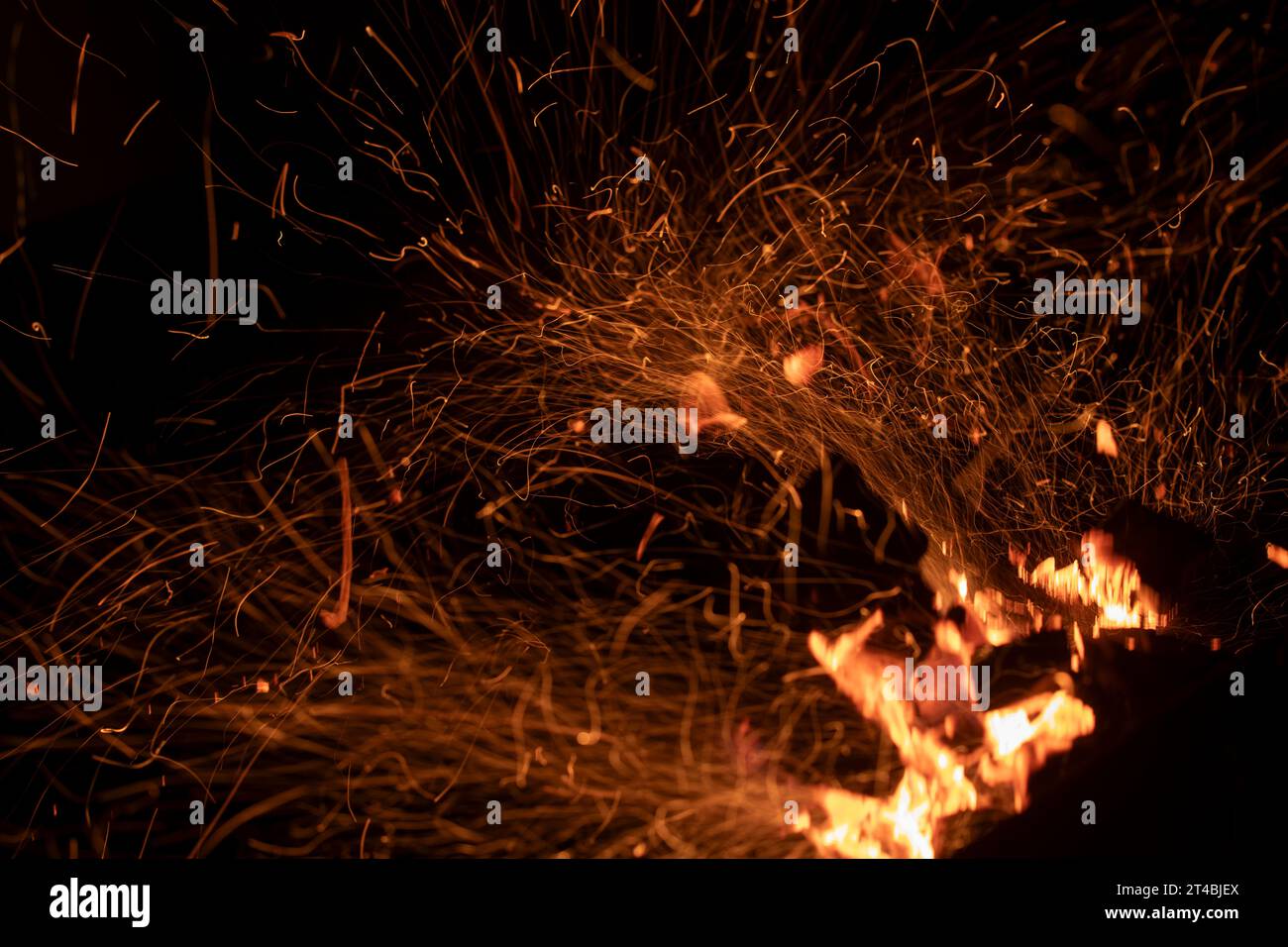 Sparks from Fire. Sparks on a black background. The combustion process ...