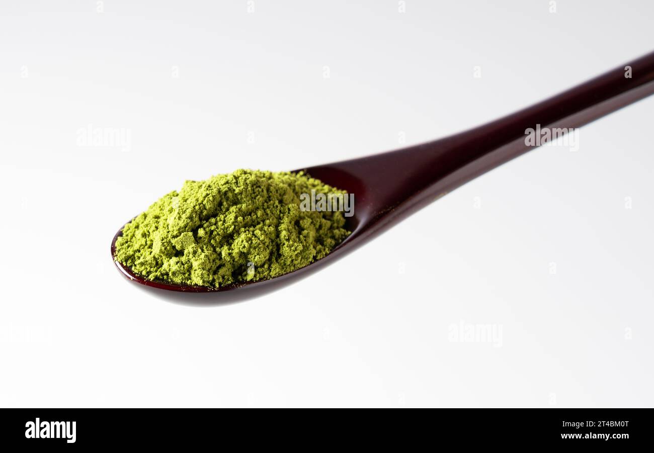 Matcha and wooden spoon on white background. Matcha powder Stock Photo ...