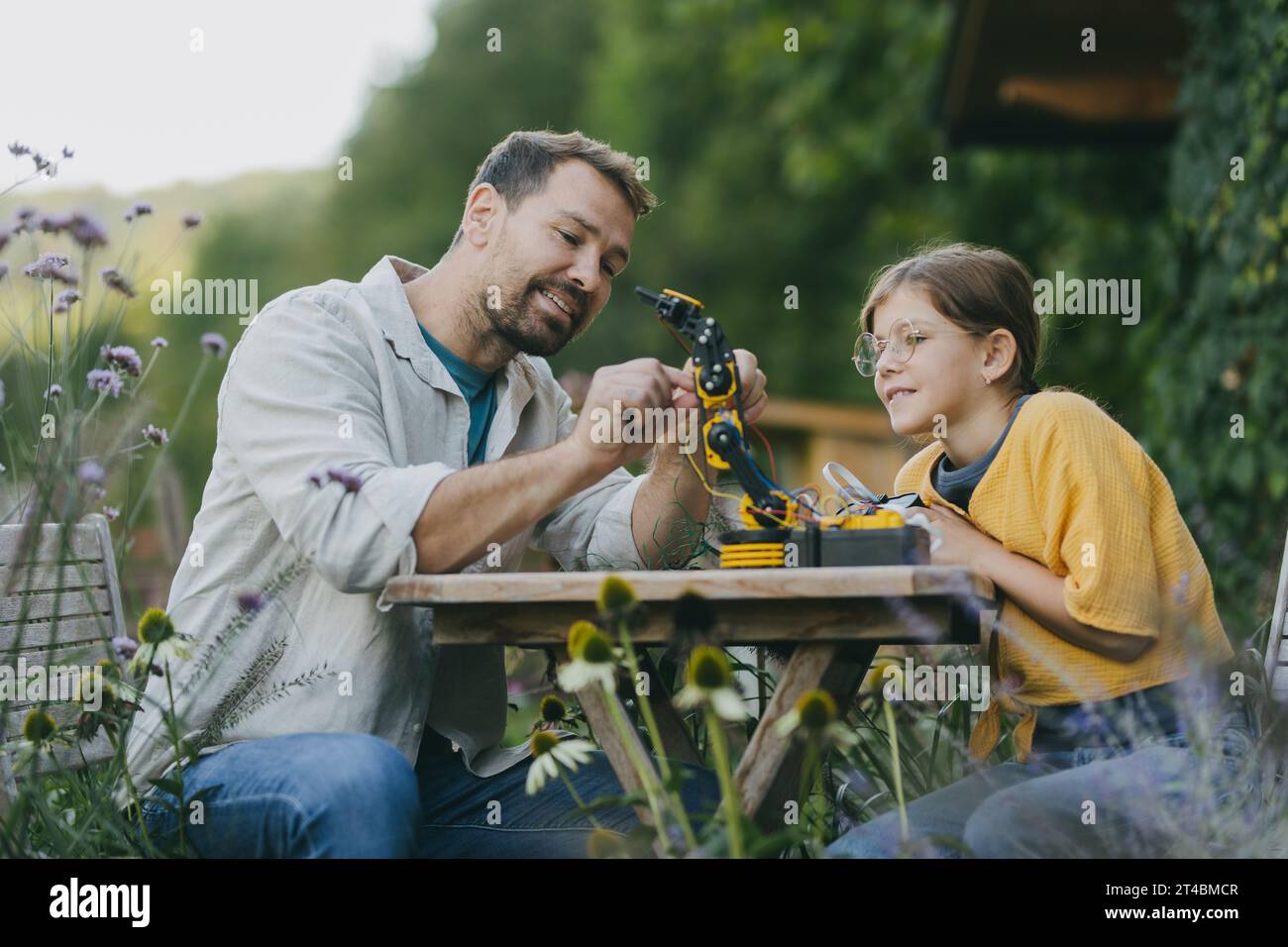Father supporting daughter in pursuing robotics, science, IT ...