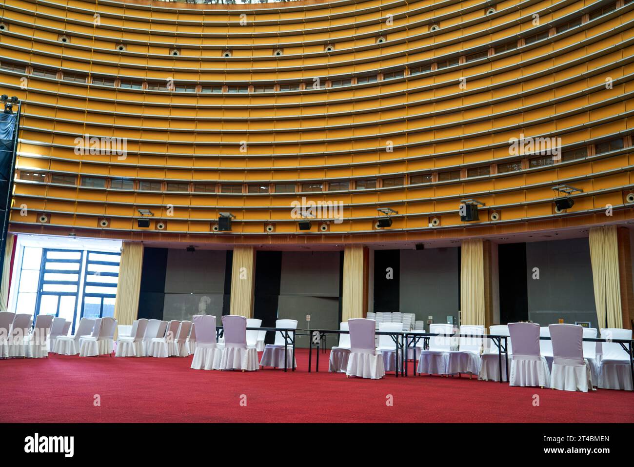 Equipment dining table and big screen in large indoor banquet hall ...