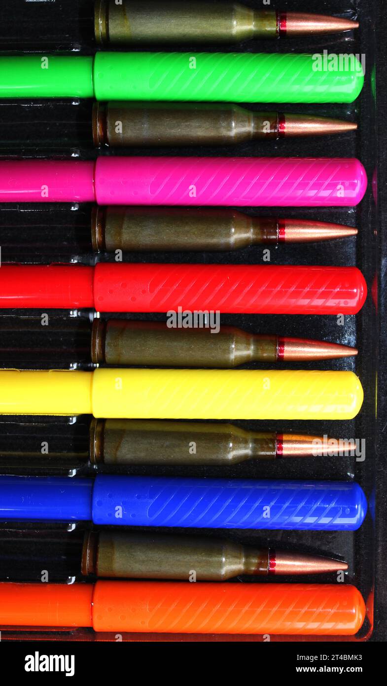 Caps Of Colored Felt Tip Pens And Rifle Bullets Laid Out Together In A ...