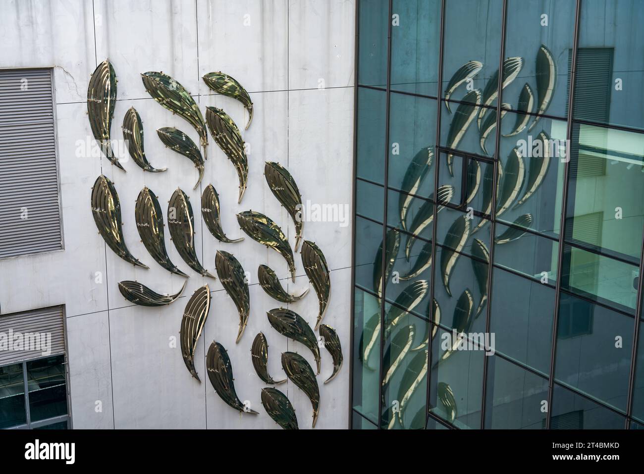 Fish sculptures on city building walls Stock Photo - Alamy