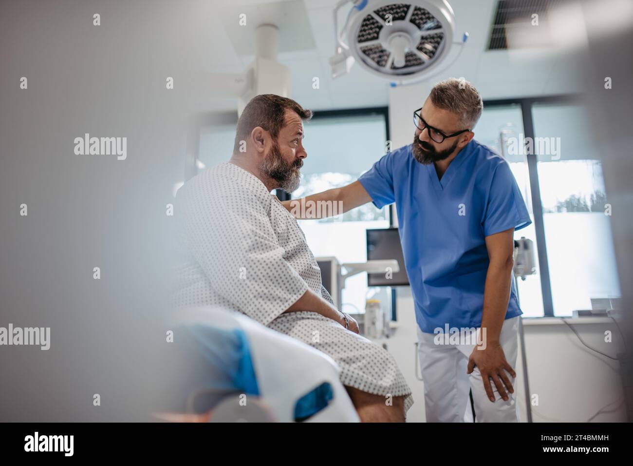 Supportive doctor soothing a worried overweight patient, discussing ...