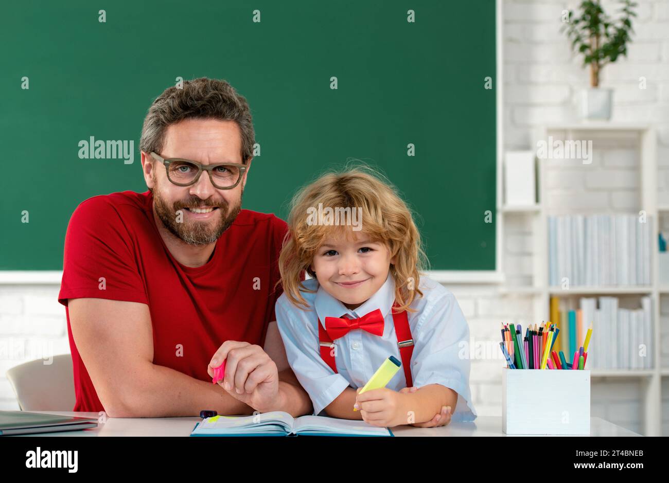 School teacher and child pupil in classroom. Education and knowledge ...