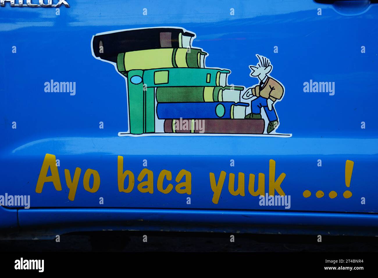 Ayo baca yuuk caption in library car. This sentense means lets read ...