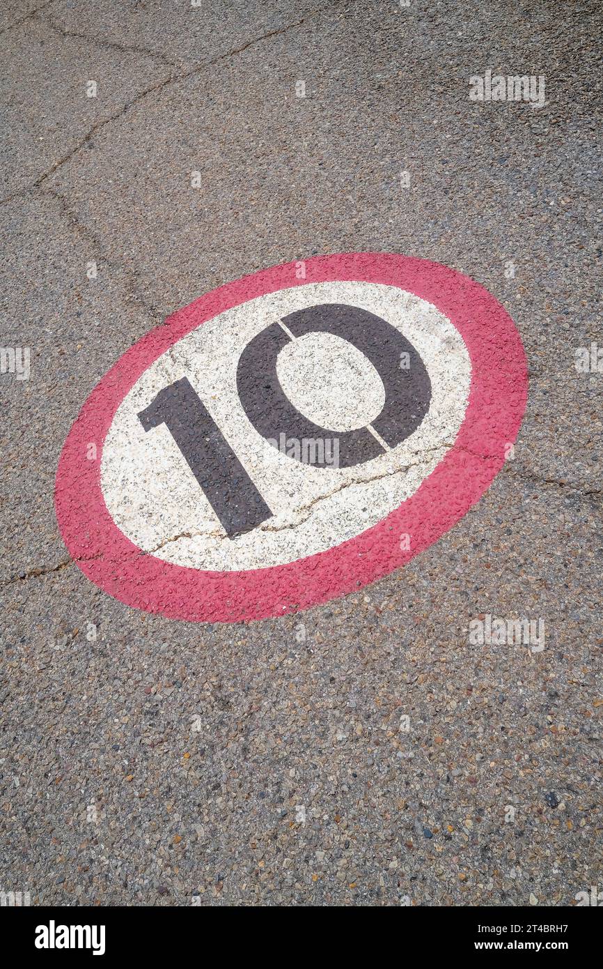 10 speed limit sign painted on road asphalt tarmac Stock Photo - Alamy