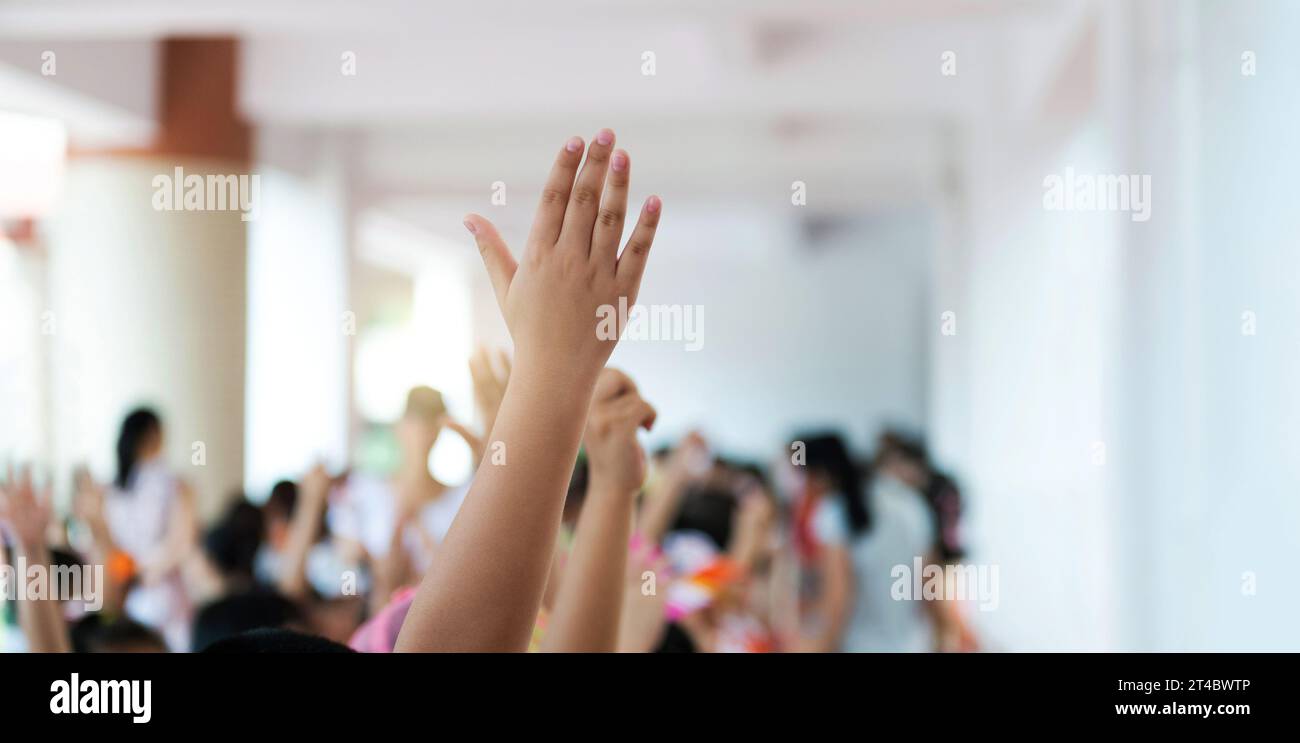 Group of happy children with their hands up Stock Photo - Alamy