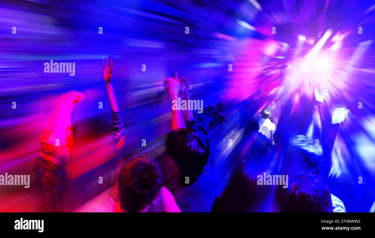 Dancing people in a disco club to the music Stock Photo - Alamy