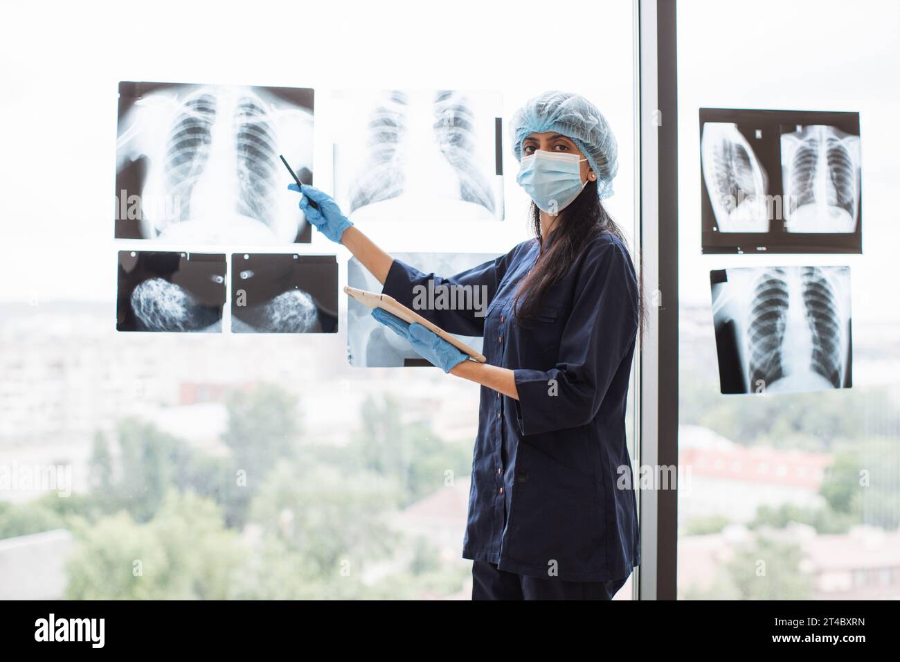 Surgeon with tablet examining x-ray scan of patient chest Stock Photo ...