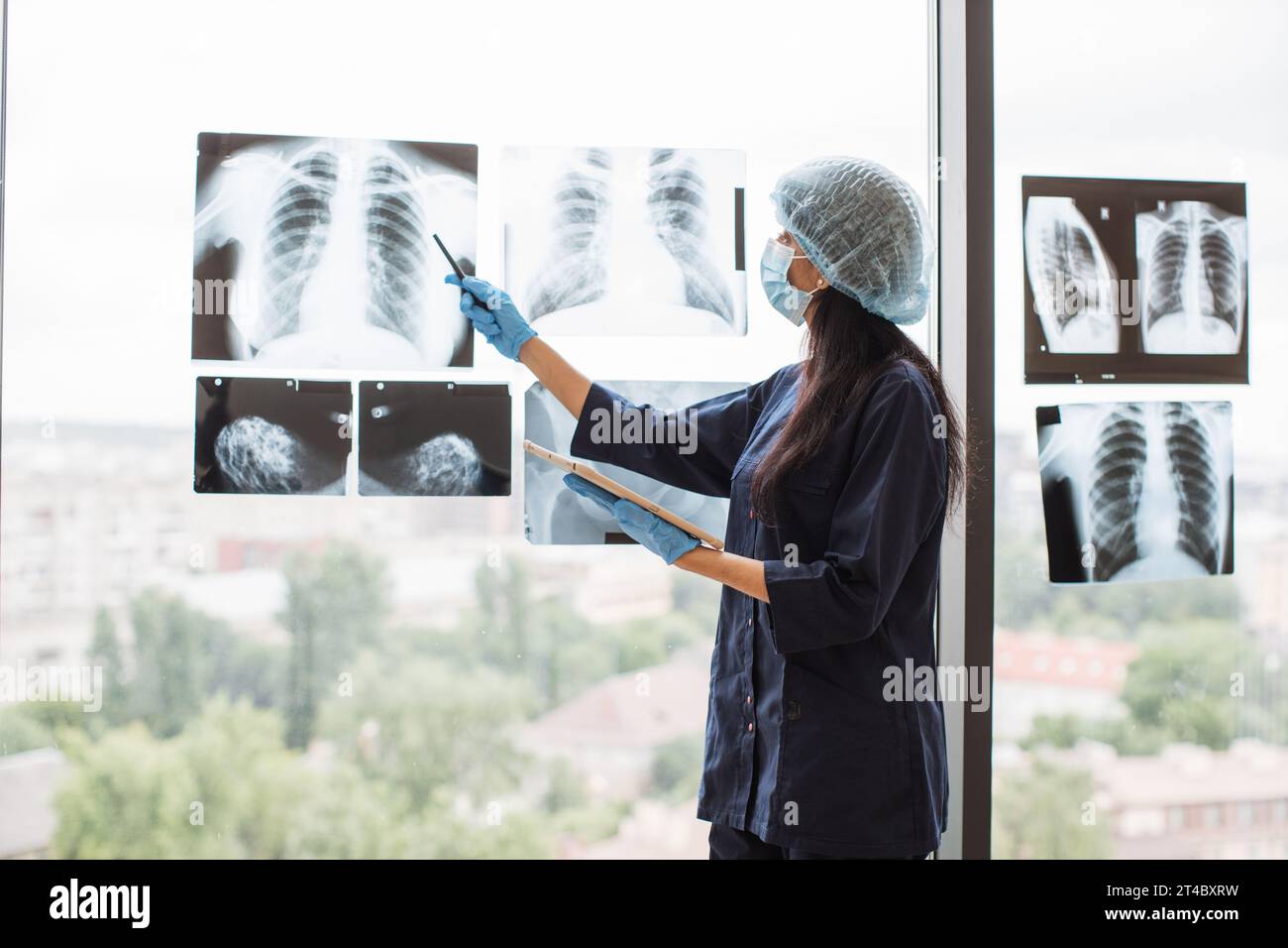 Surgeon with tablet examining x-ray scan of patient chest Stock Photo ...