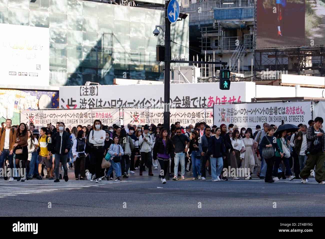 Tokyo, Japan. 30th Oct, 2023. Pedestrians walk past signboards ...