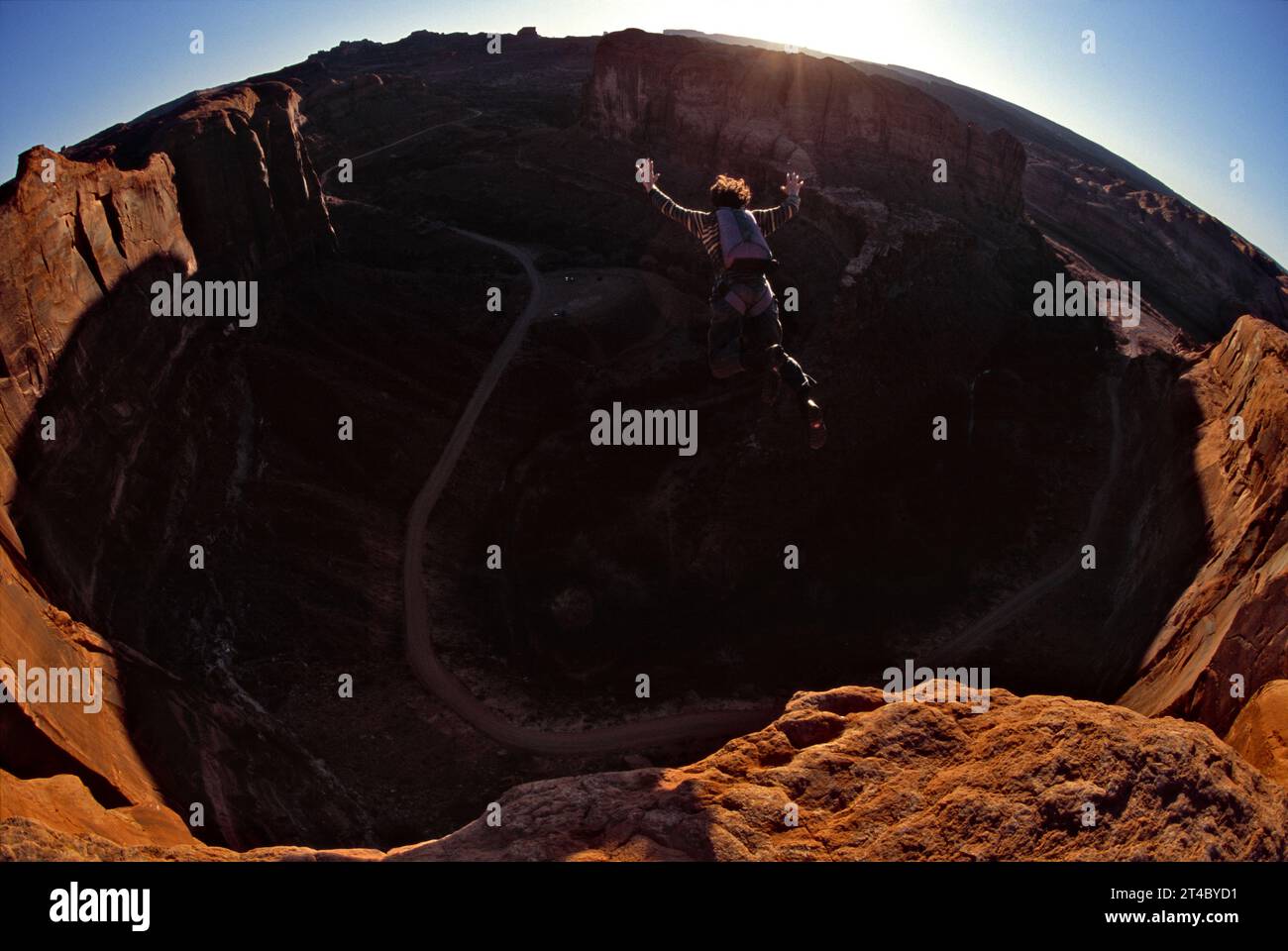 A man base jumping off the Tombstone cliff outside of Moab, Utah, USA ...