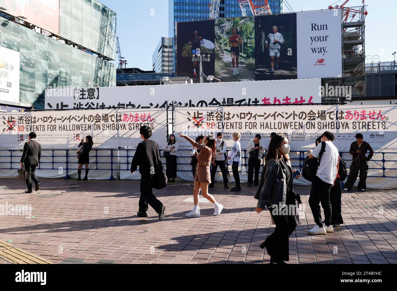 Tokyo, Japan. 30th Oct, 2023. Pedestrians walk past signboards ...