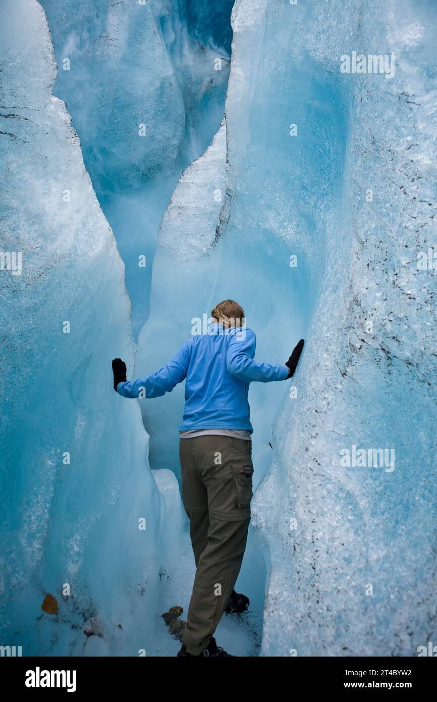 Woman looking into chasm in glacier near McCarthy, Alaska Stock Photo ...