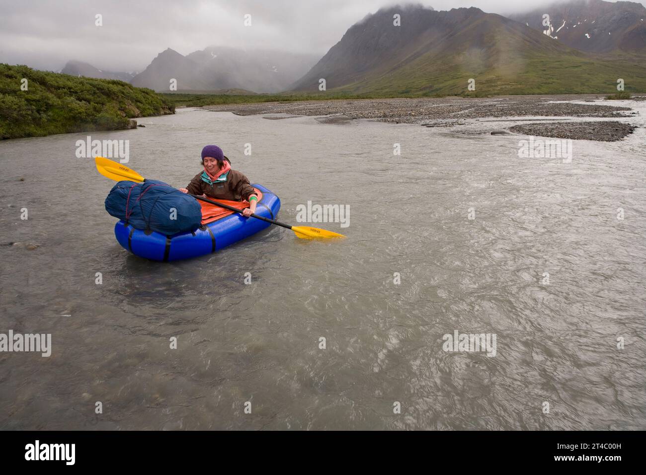Woman floating down a river in a very small raft in Denali National ...