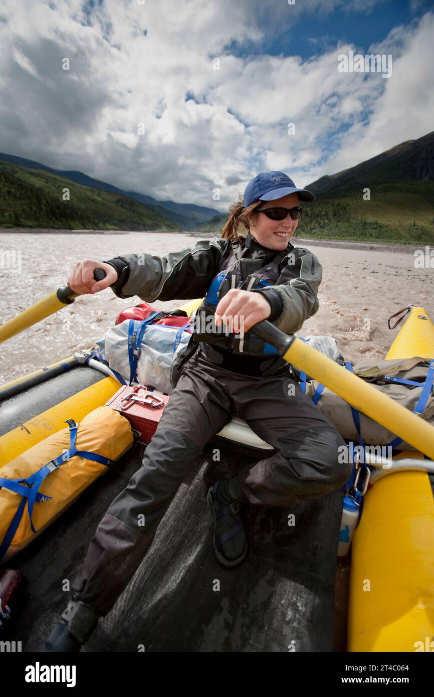 A woman rowing a raft down the Jacksina river, Wrangell-St. Elias ...