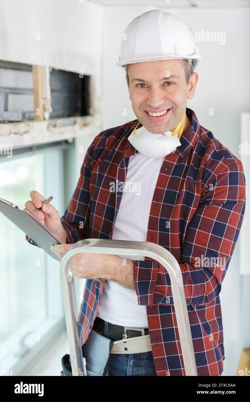 a handsome smiling worker indoors Stock Photo - Alamy