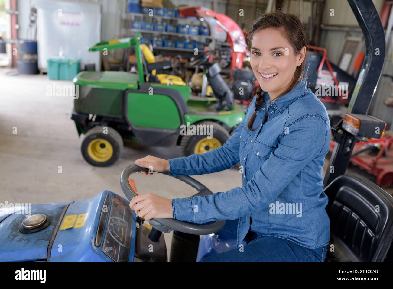 adult and young farmers working at agricultural machinery in farm Stock ...