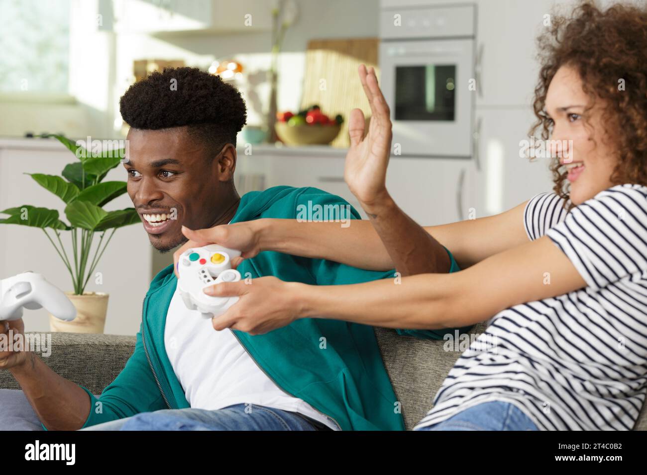 friends playing computer game using cordless console Stock Photo - Alamy