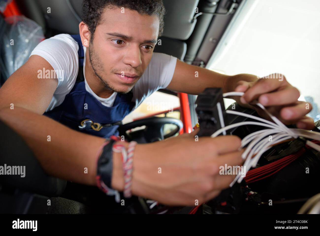 car mechanic working cables of a dead battery Stock Photo - Alamy